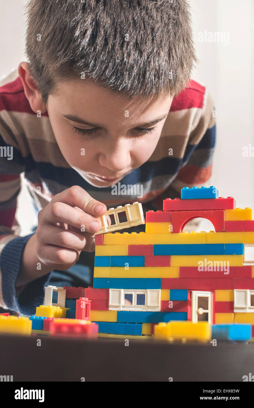 Boy playing with building bricks Stock Photo - Alamy