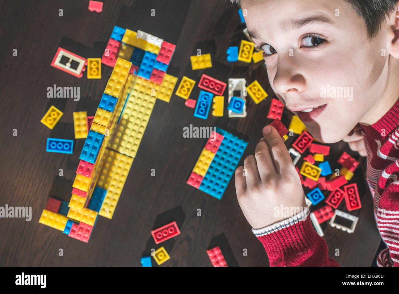Boy playing with building bricks on a table Stock Photo - Alamy