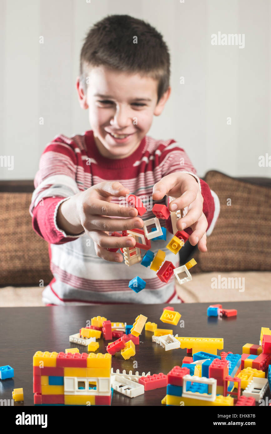 Boy playing with building bricks Stock Photo - Alamy