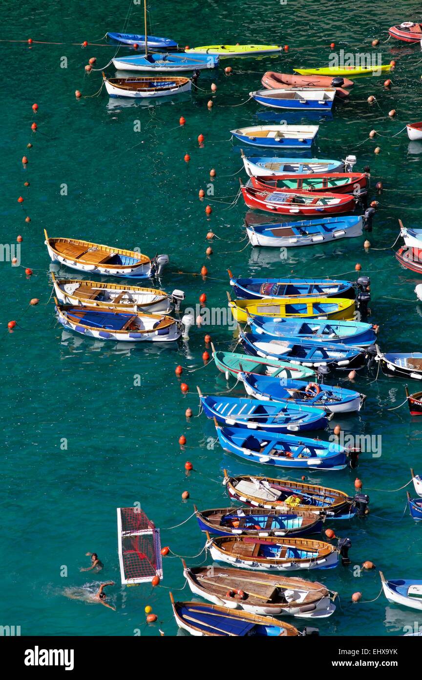 Long line of moored boats with two water polo players Stock Photo - Alamy