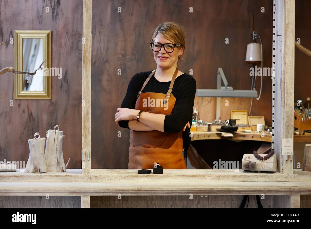 Portrait of smiling goldsmith in her shop Stock Photo - Alamy