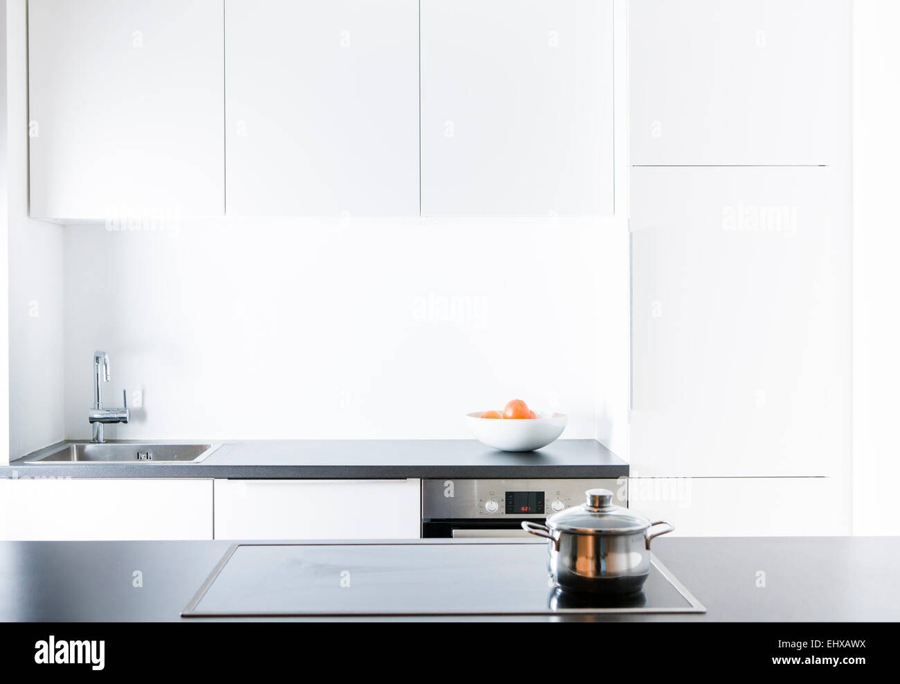 Modern kitchen, pot on cooker Stock Photo - Alamy