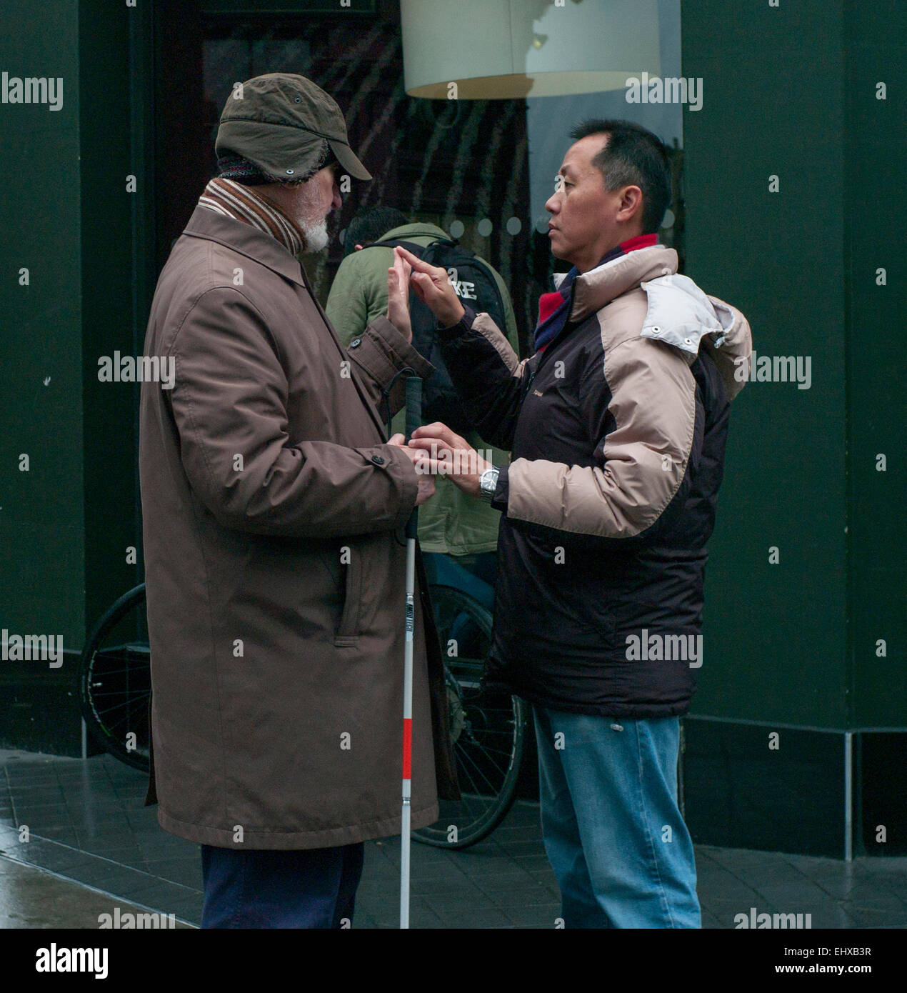sign or finger spell A deaf-blind person chats with his friend, using ...