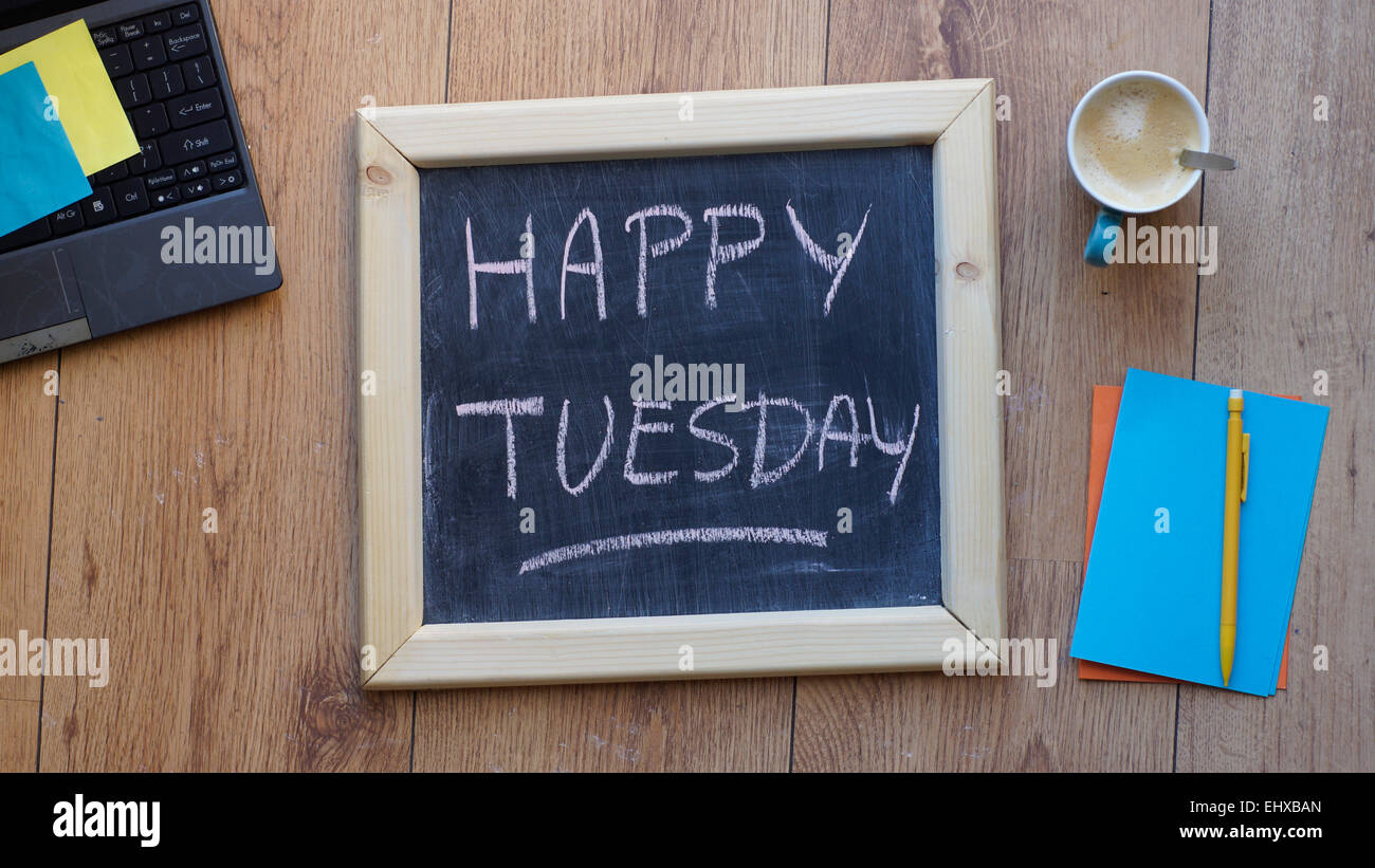 Happy tuesday written on a chalkboard at the office Stock Photo - Alamy