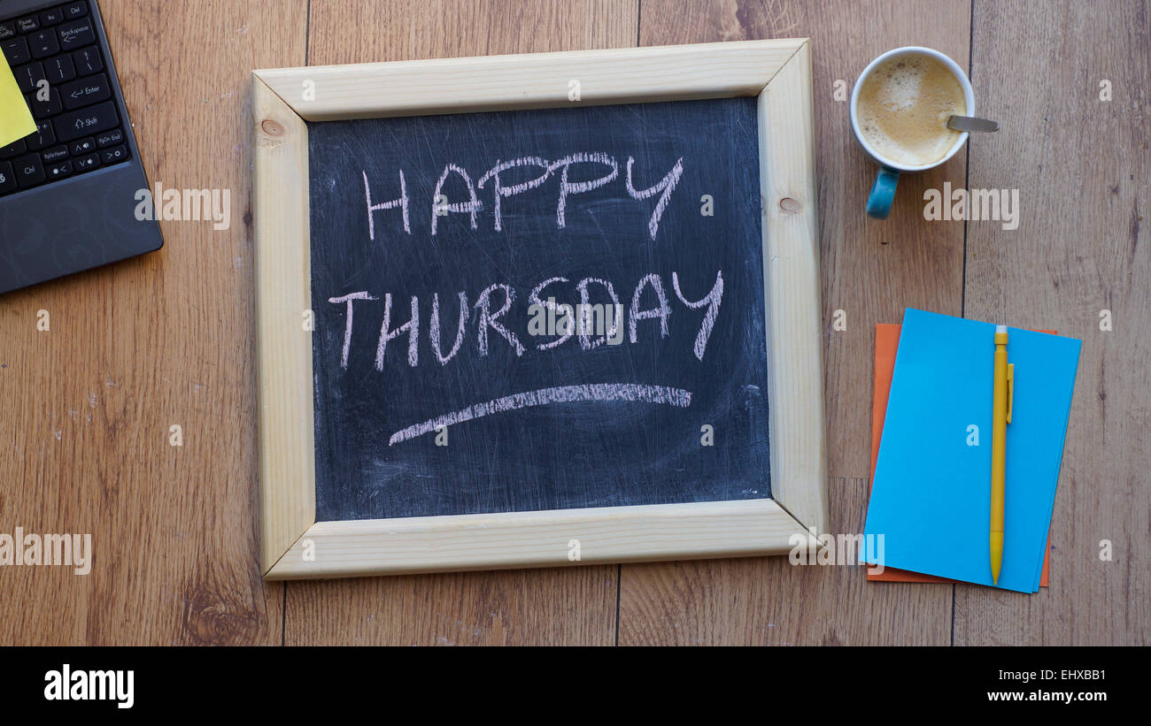 Happy thursday written on a chalkboard at the office Stock Photo - Alamy