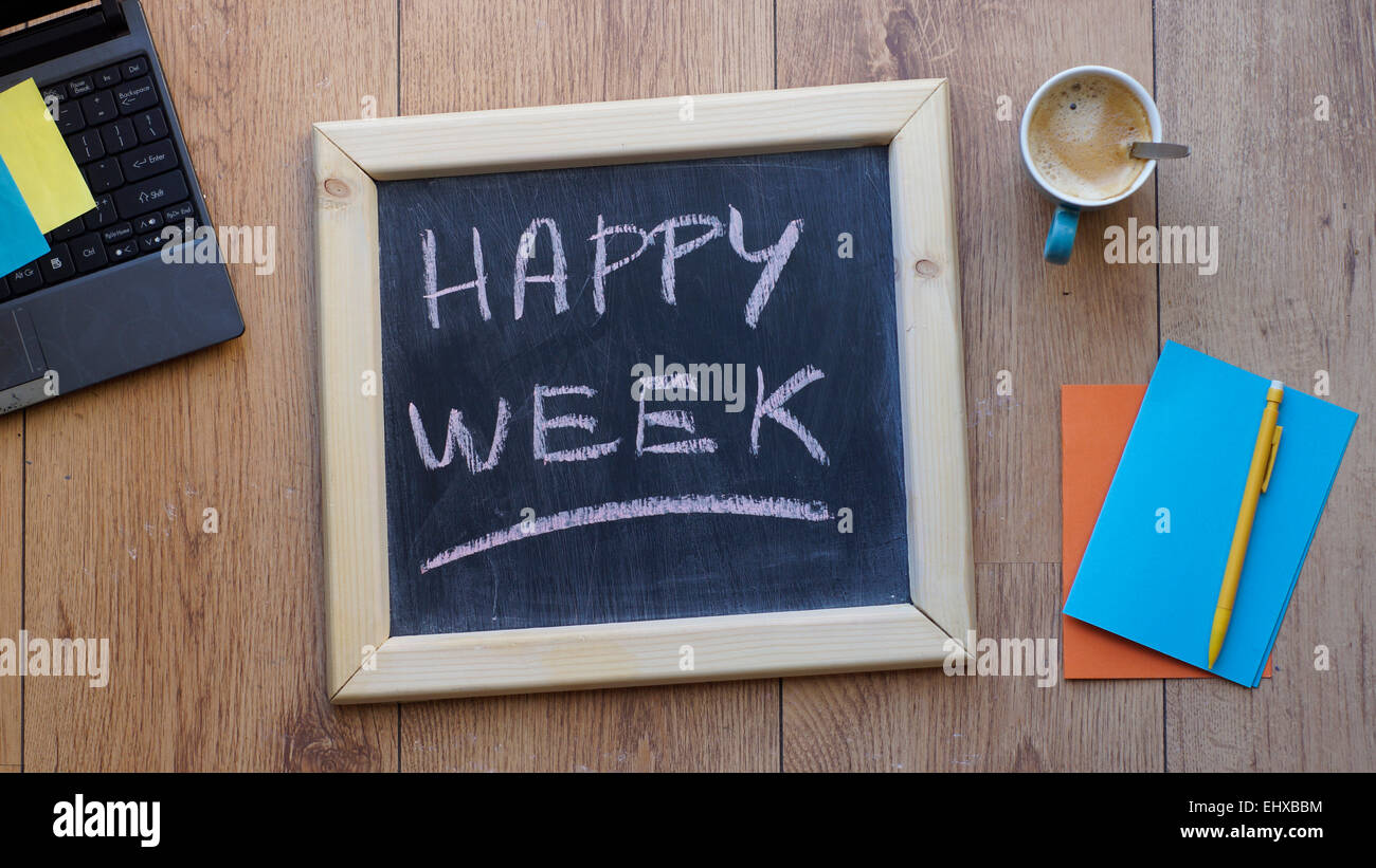 Happy week written on a chalkboard at the office Stock Photo - Alamy