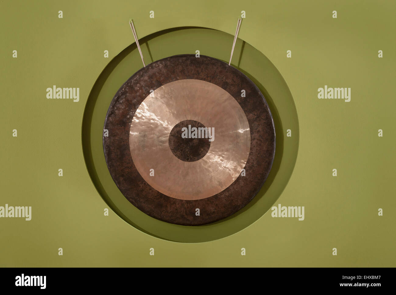 Close up gong hanging wall fitness studio Stock Photo - Alamy