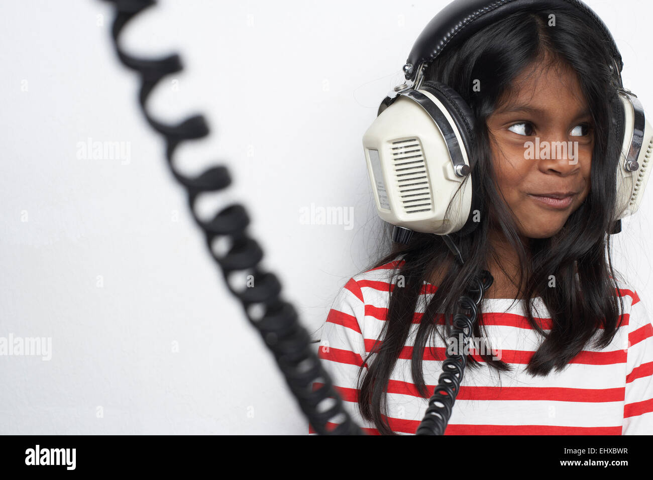 Portrait of smiling girl hearing music with headphones Stock Photo - Alamy