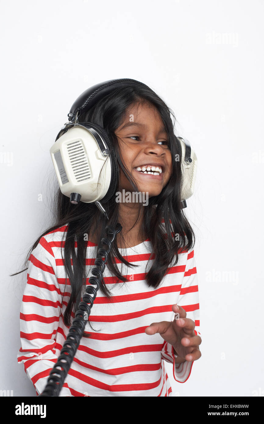 Portrait of smiling girl hearing music with headphones Stock Photo - Alamy