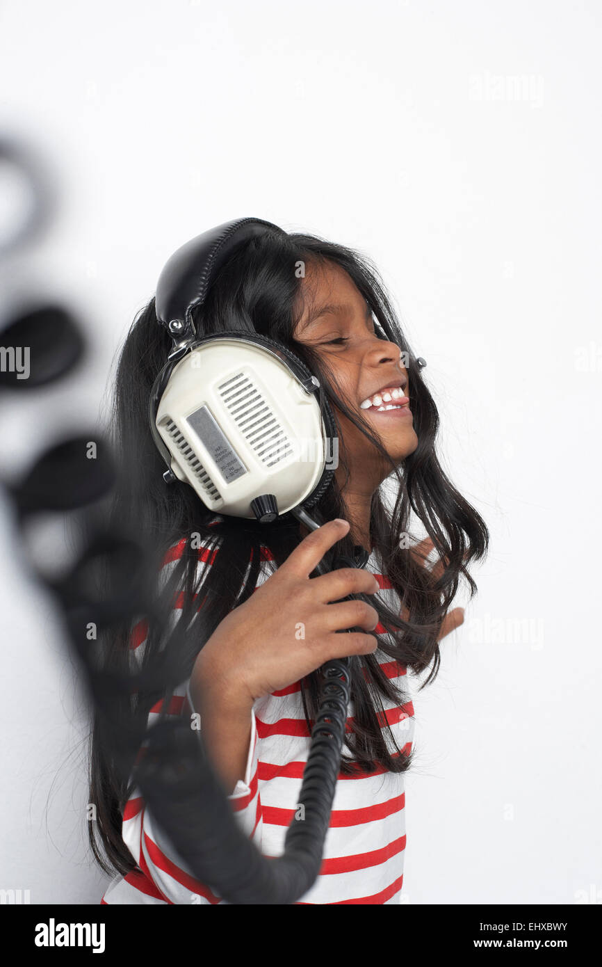 Smiling girl hearing music with headphones Stock Photo - Alamy