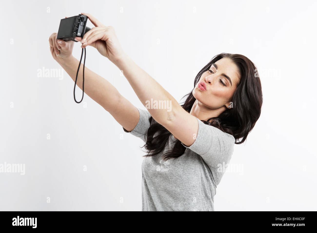 Portrait of young woman taking a selfie with camera Stock Photo - Alamy