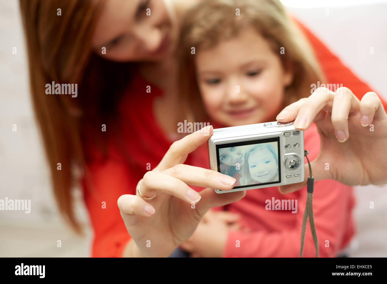 close up of happy mother and daughter with camera Stock Photo - Alamy