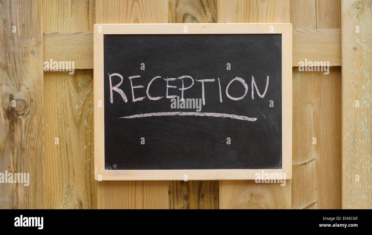 Reception written on a chalkboard written at a wooden wall Stock Photo ...