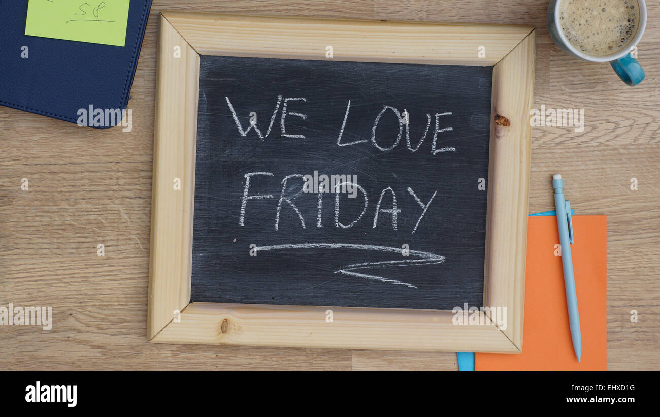 We love friday written on a chalkboard at the office Stock Photo - Alamy