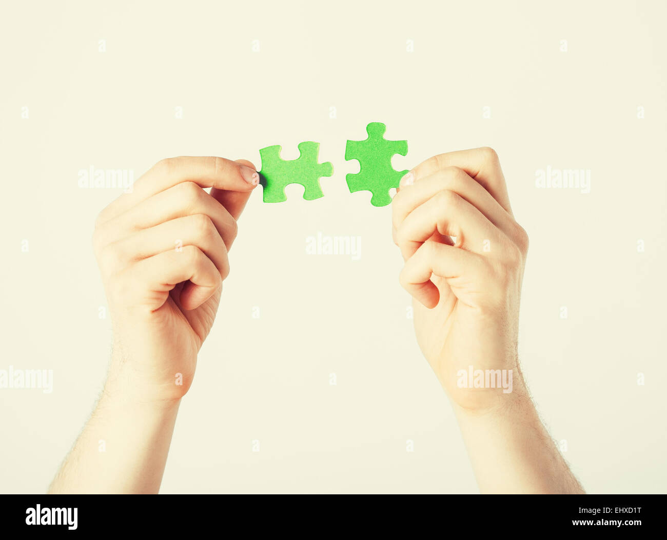 two hands trying to connect puzzle pieces Stock Photo - Alamy