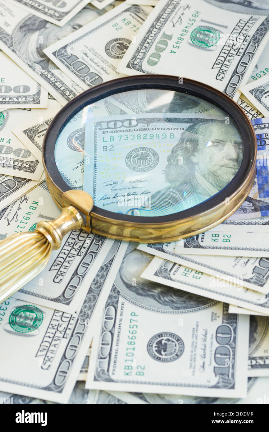 money under manifying glass Stock Photo - Alamy