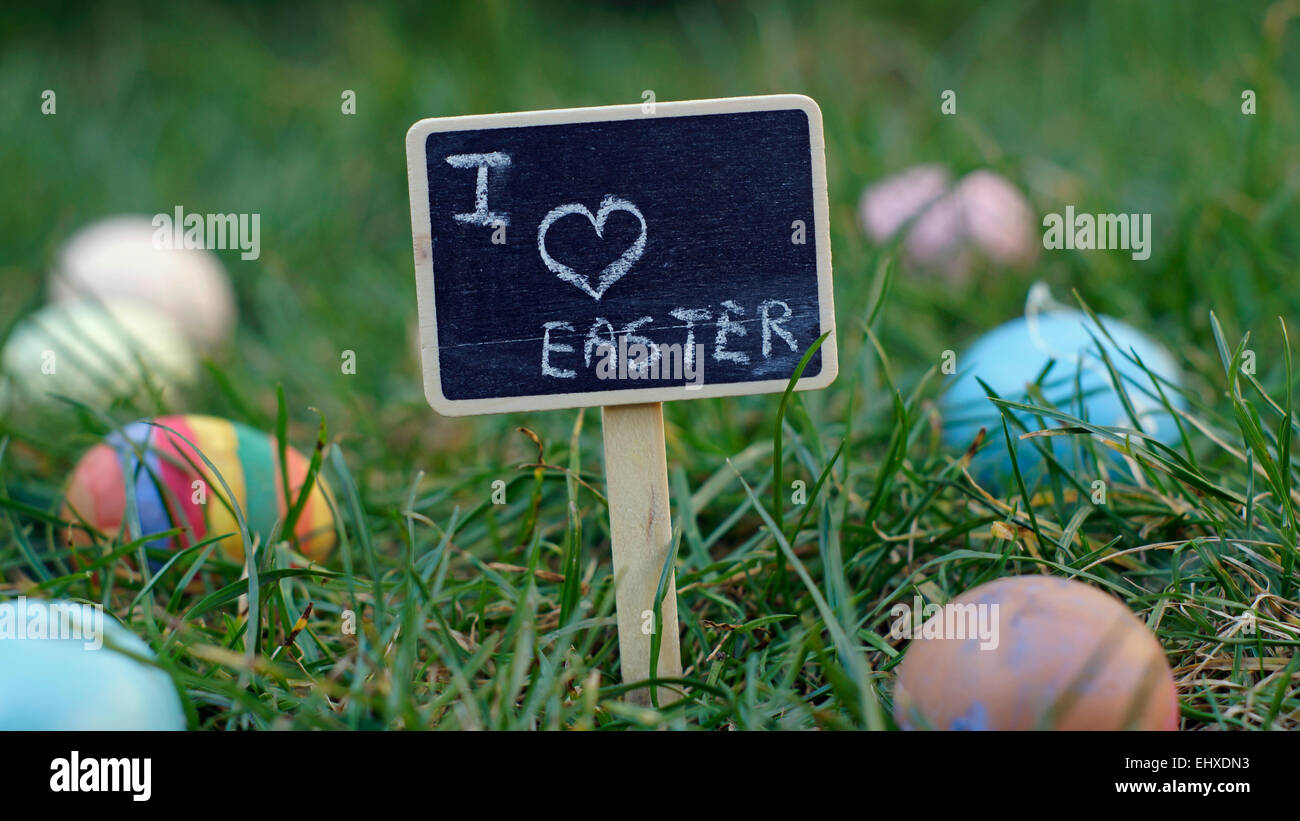 I love easter written on a chalkboard standing in grass between easter ...