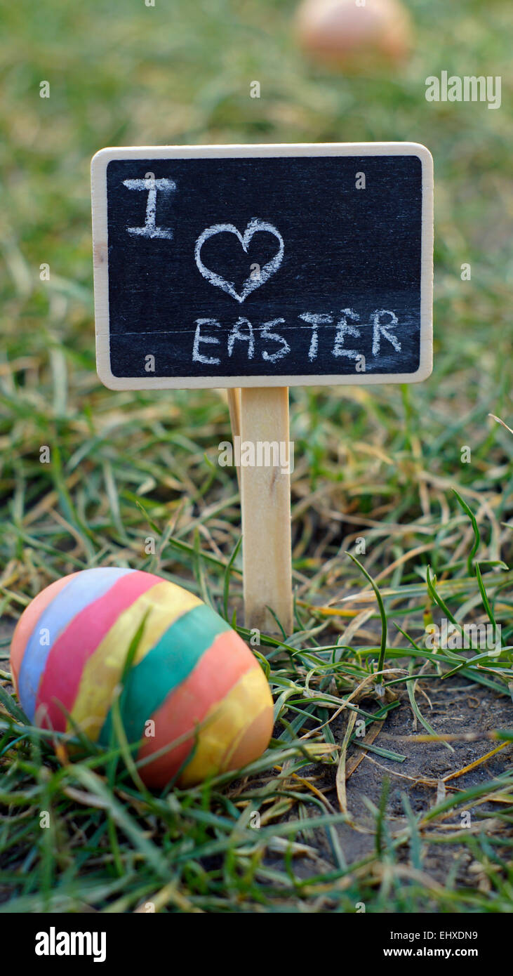 I love easter written on a chalkboard standing in grass between easter ...