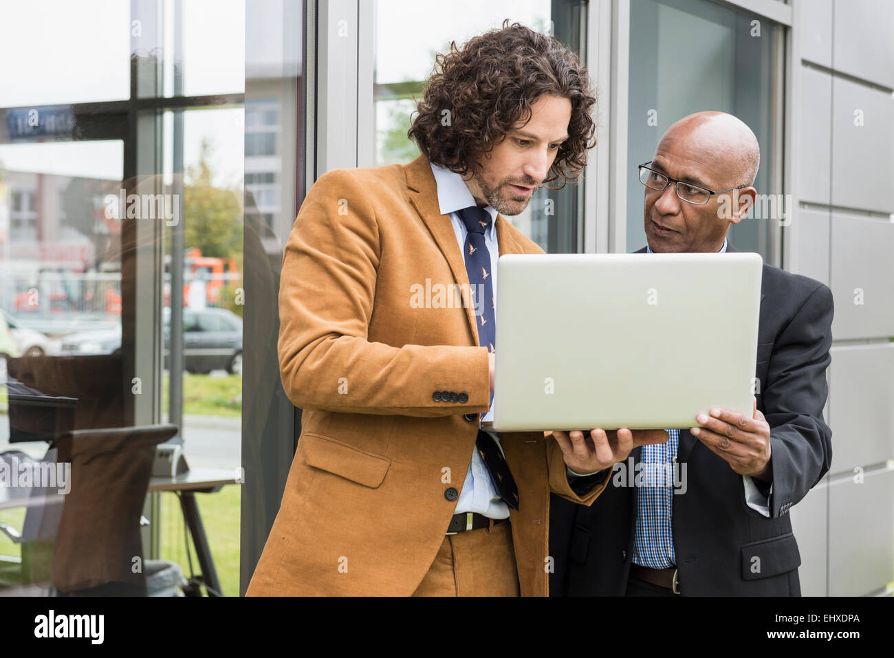Two businessmen laptop computer suit meeting Stock Photo - Alamy