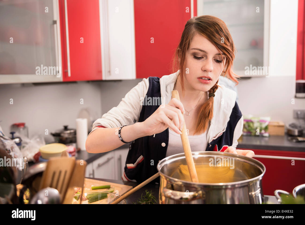 Young woman cooking in the kitchen, Munich, Bavaria, Germany Stock ...