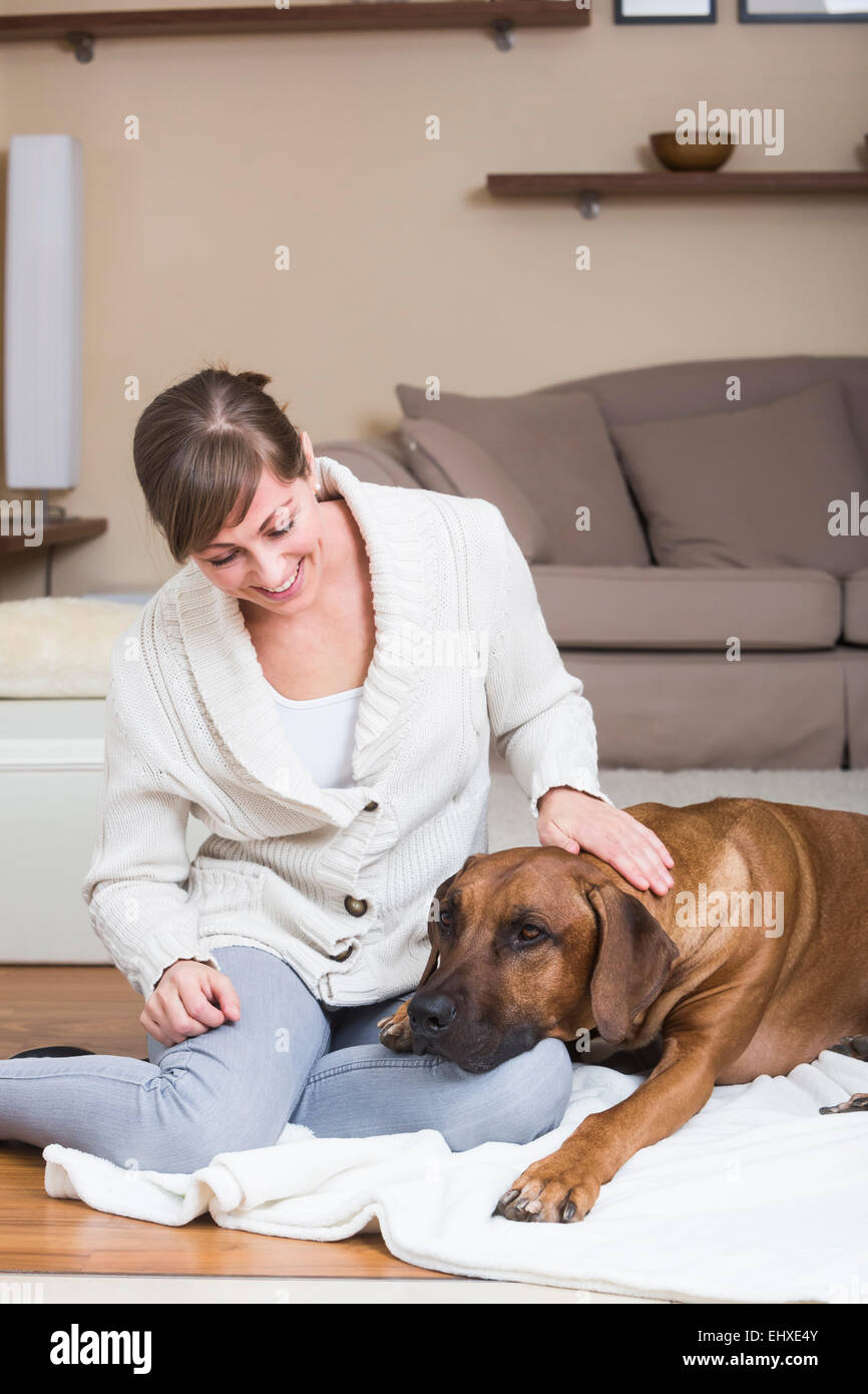 Woman caressing her Rhodesian Ridgeback dog Stock Photo - Alamy