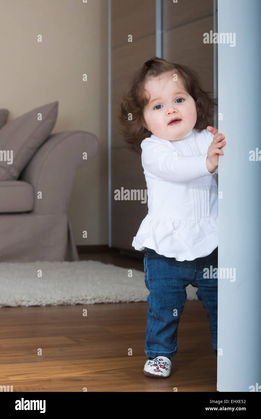 Little girl trying first steps Stock Photo - Alamy