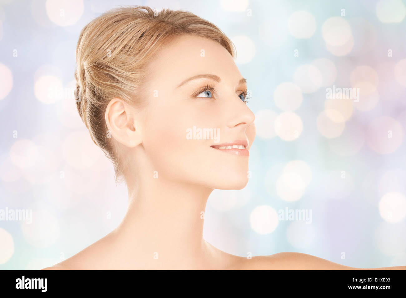 beautiful young woman face over blue background Stock Photo - Alamy