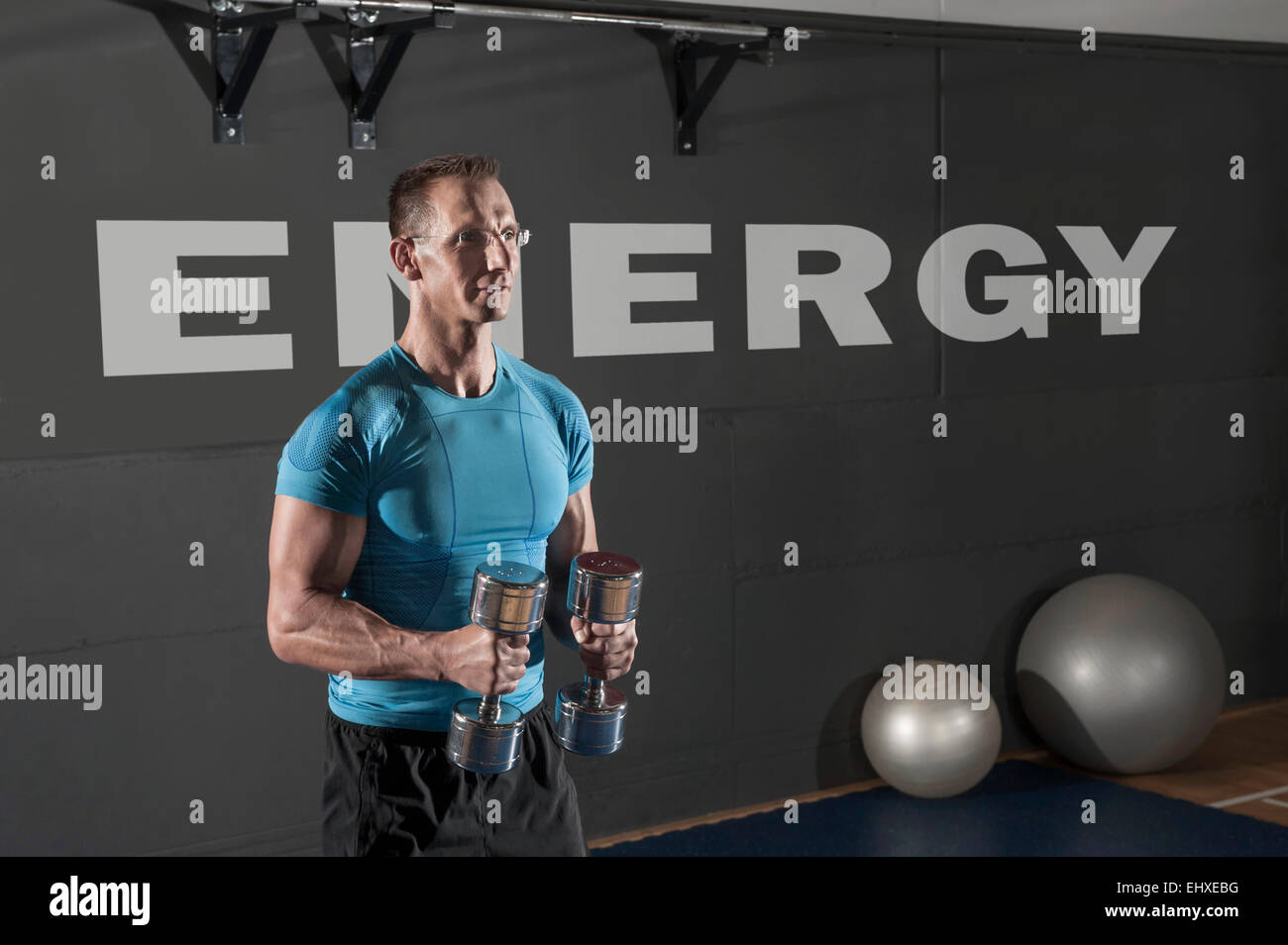 Muscular man fitness weight training posing Stock Photo - Alamy