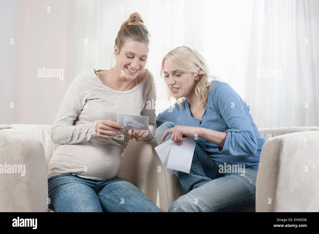 Two girlfriends women looking ultrasonic scan Stock Photo - Alamy