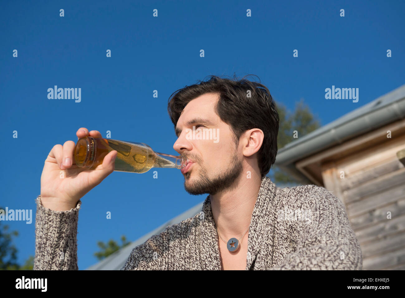 Young man drinking beer hi-res stock photography and images - Alamy