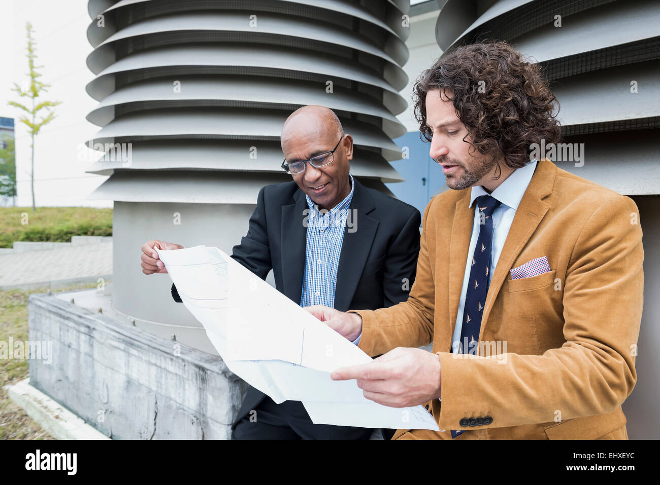 African architect client two men blueprint meeting Stock Photo - Alamy