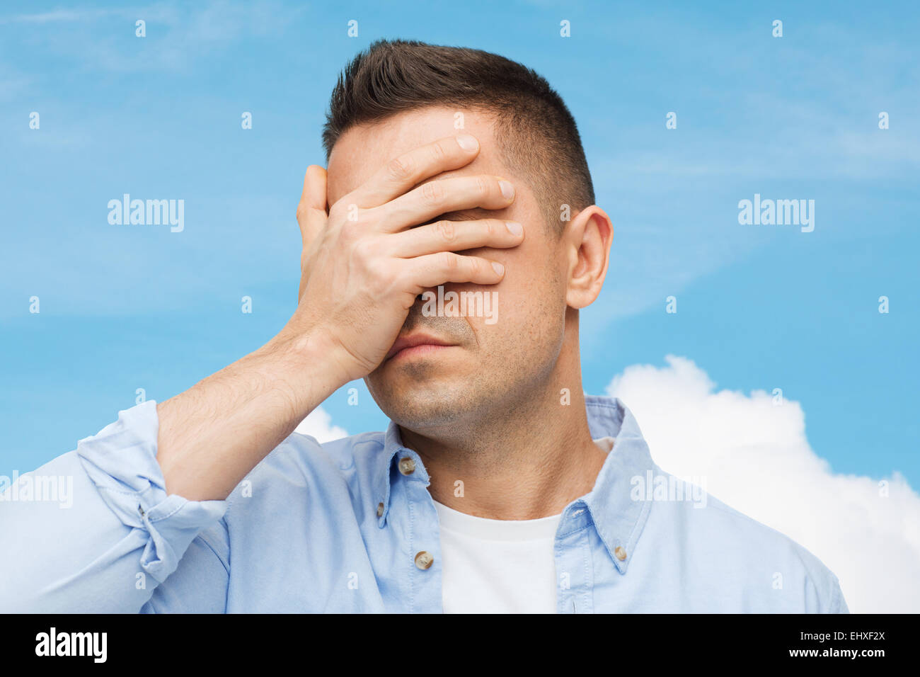 unhappy man covering his eyes by hand Stock Photo - Alamy