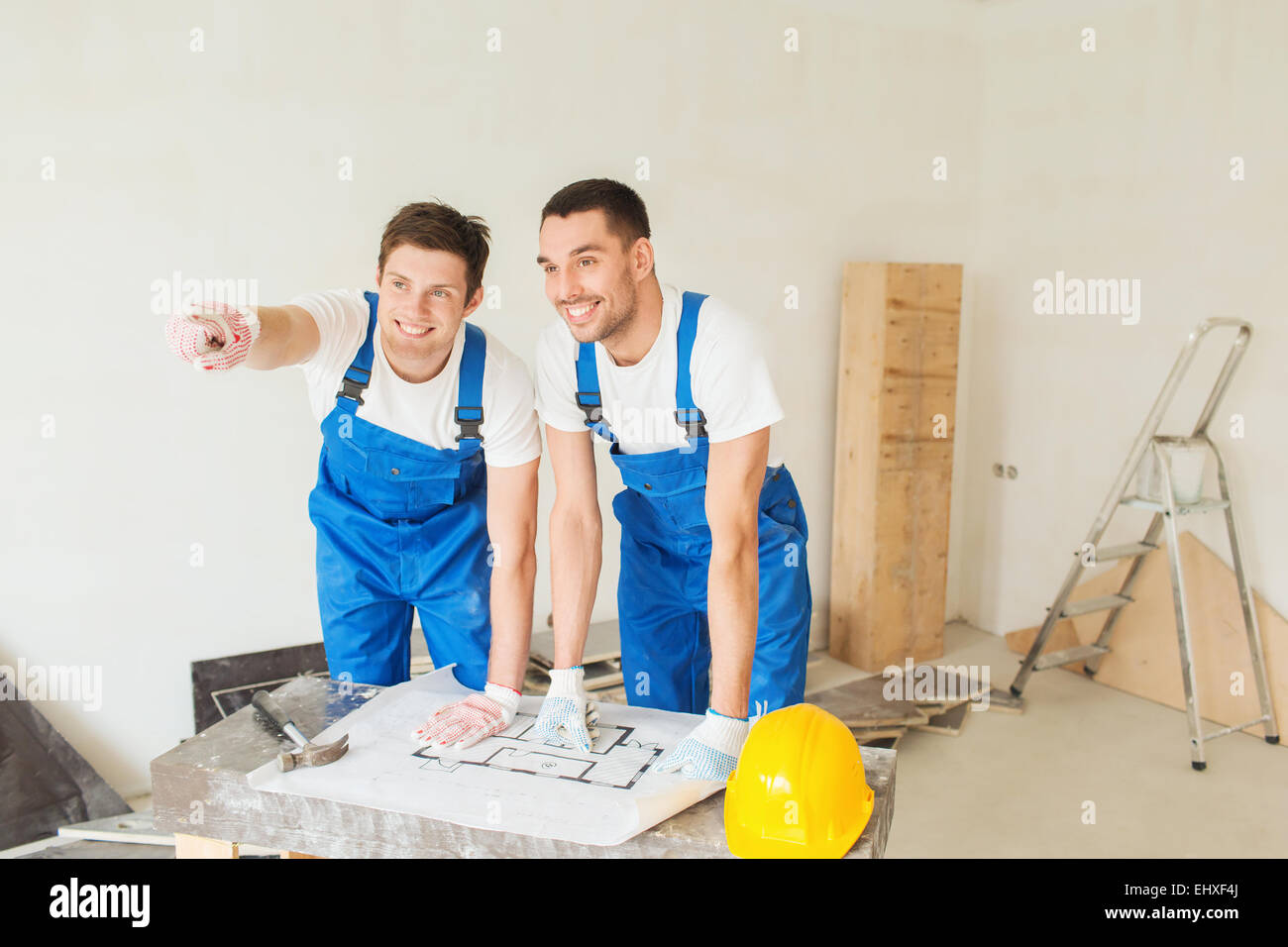 group of builders with blueprint Stock Photo - Alamy