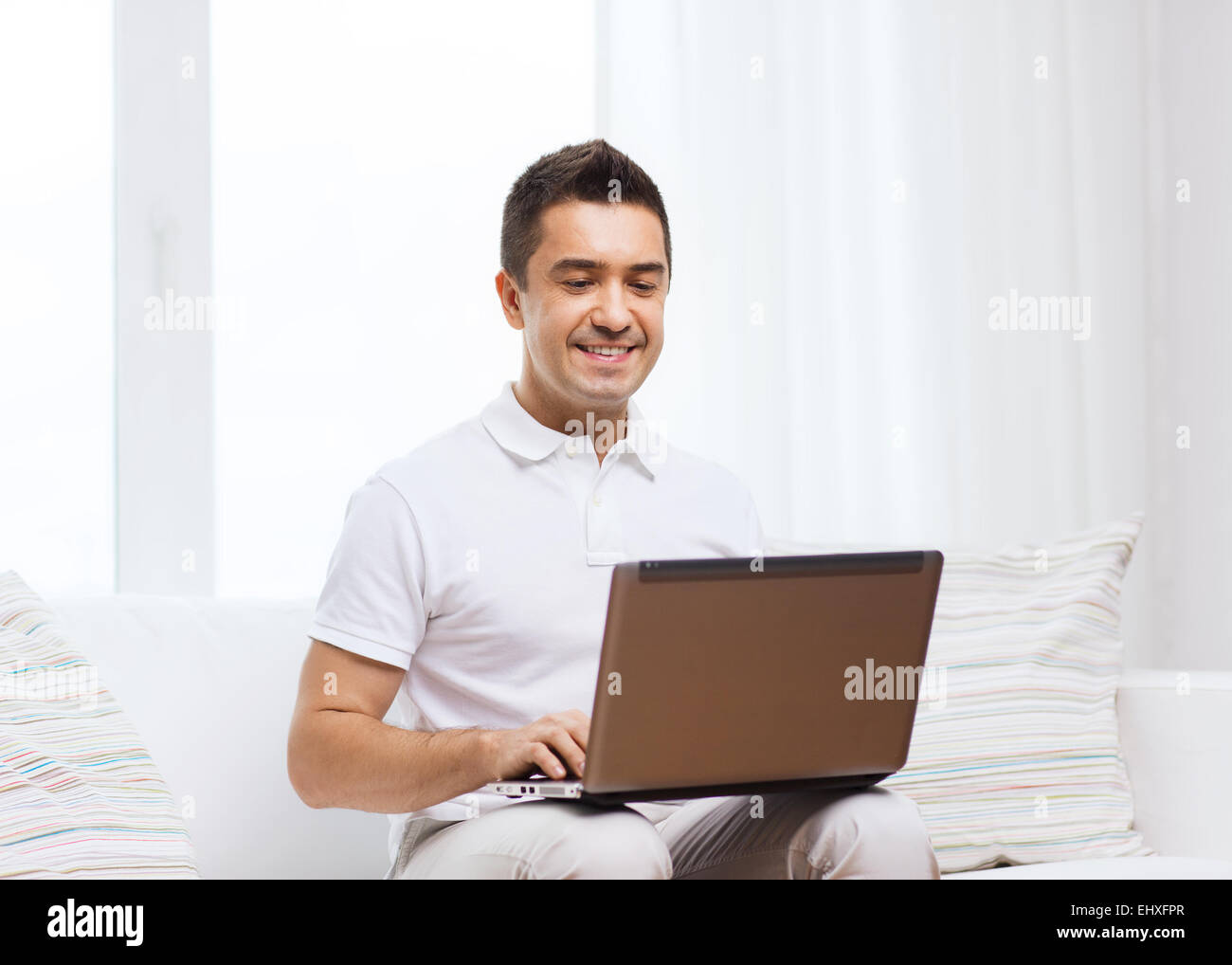 happy man working with laptop computer at home Stock Photo - Alamy