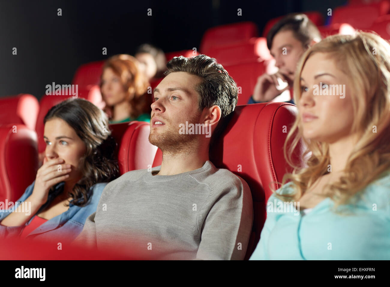happy friends watching horror movie in theater Stock Photo - Alamy