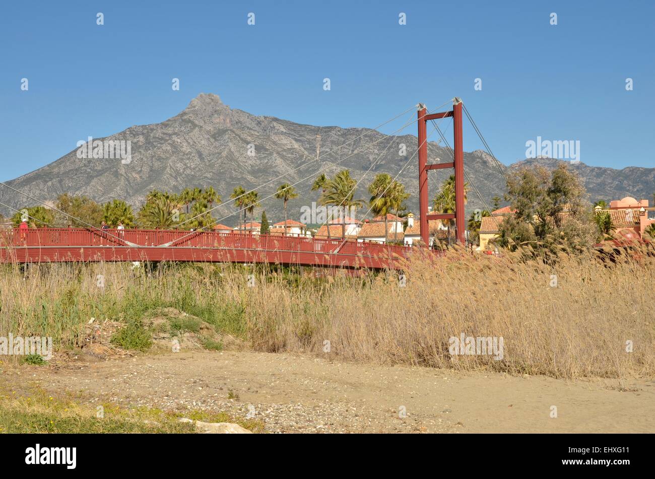 Red wooden bridge at the mouth of Green River on the beach in Marbella ...