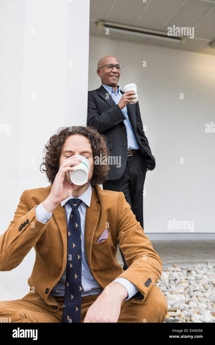 Two businessmen drinking coffee taking break Stock Photo - Alamy