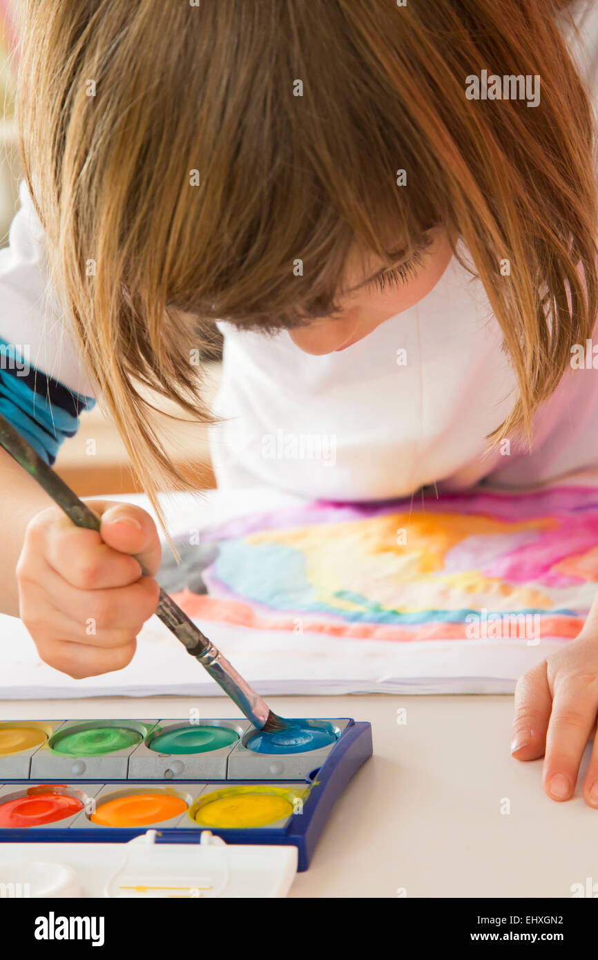 Little girl painting with watercolours Stock Photo - Alamy