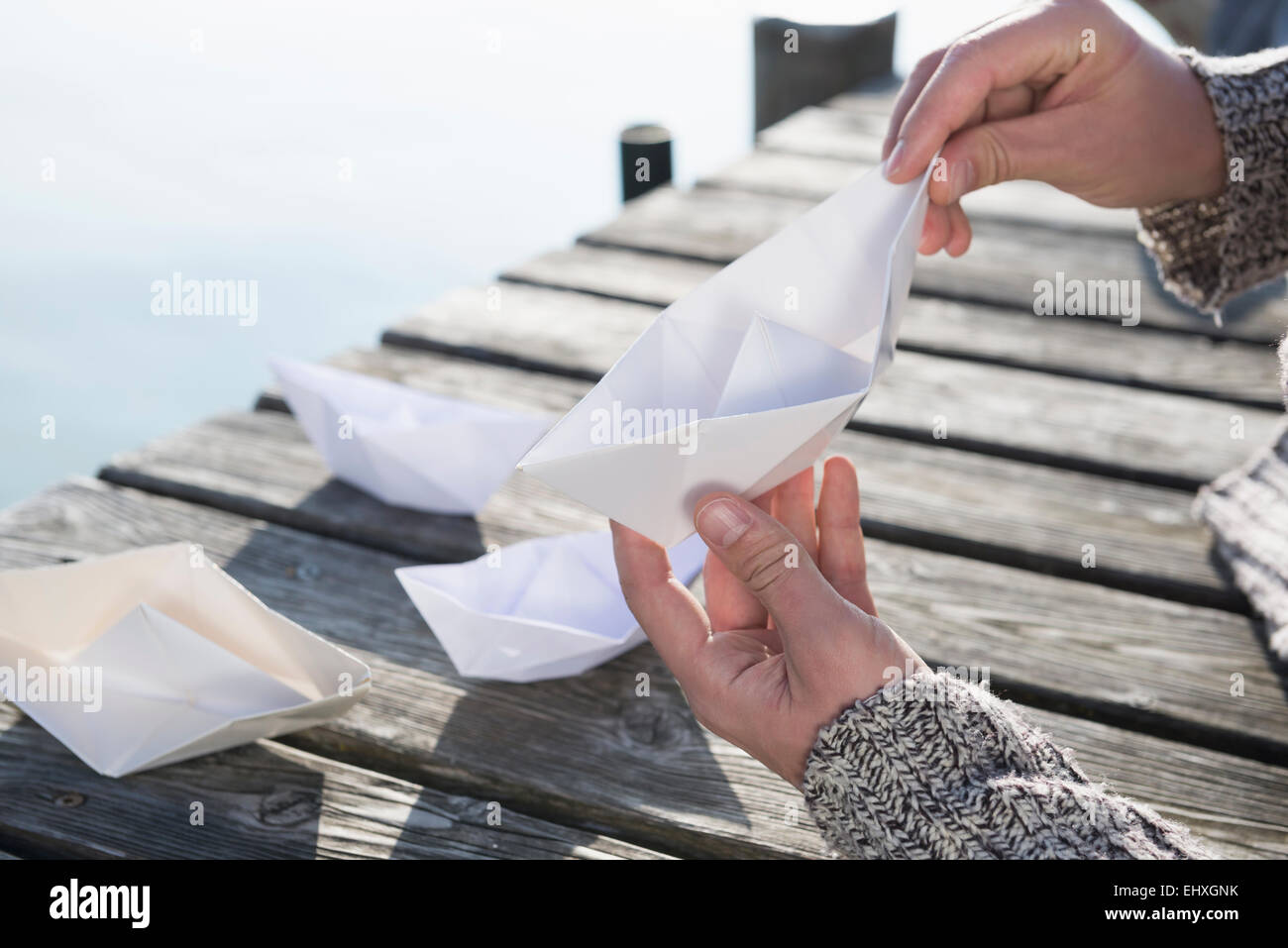 Detail close up man building paper boat Stock Photo - Alamy