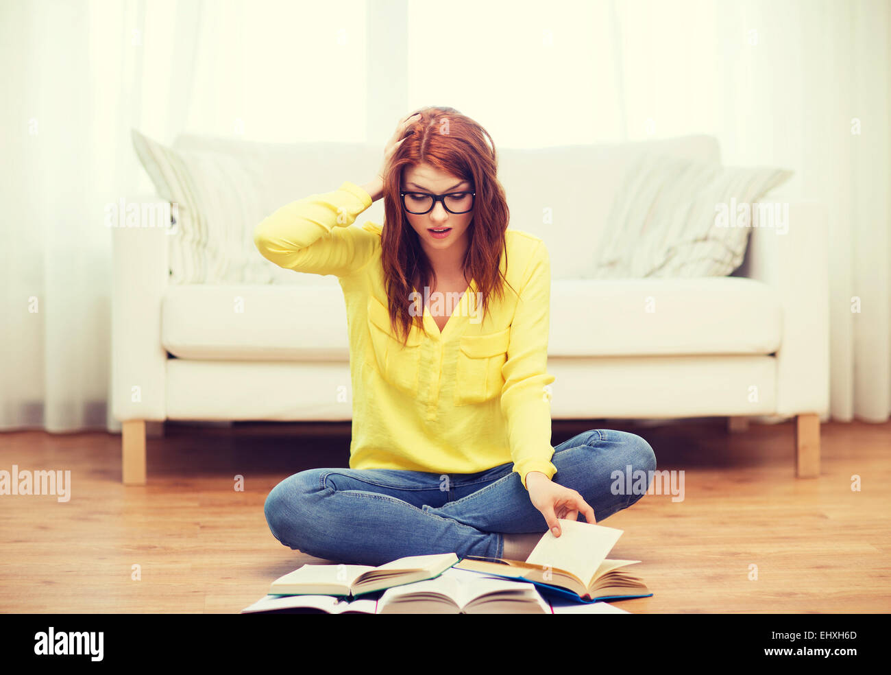 stressed student girl reading books at home Stock Photo - Alamy