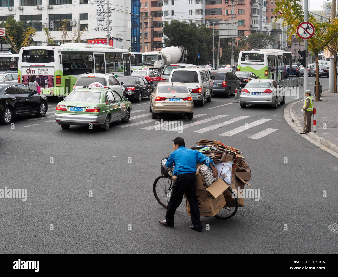 Man pushing a bike full of cardboard and paper for recycling Stock ...