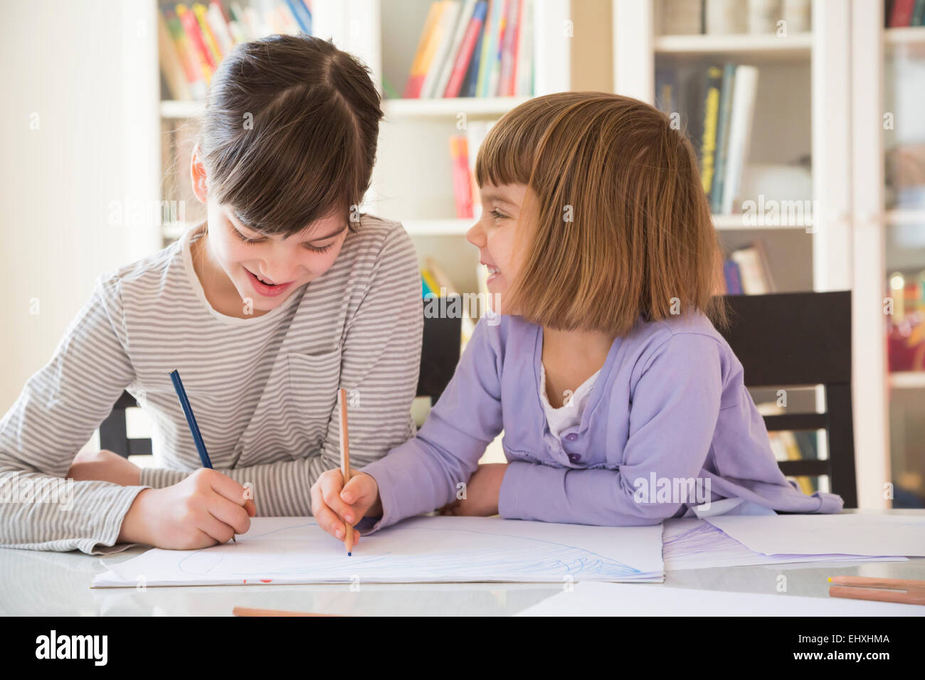 Two sisters drawing Stock Photo - Alamy