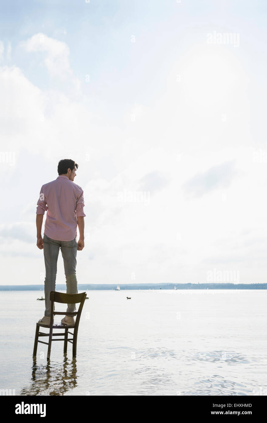Man standing behind chair hi-res stock photography and images - Alamy