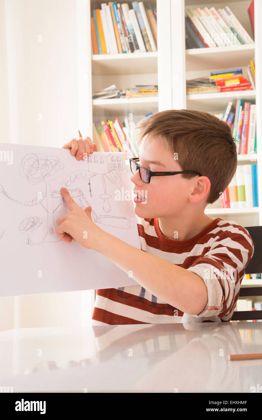 Boy showing his drawing Stock Photo - Alamy
