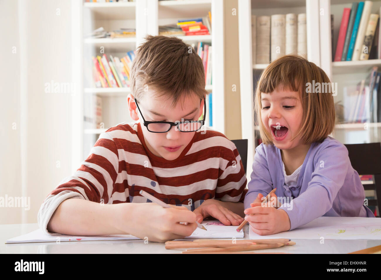Brother and sister drawing together Stock Photo - Alamy