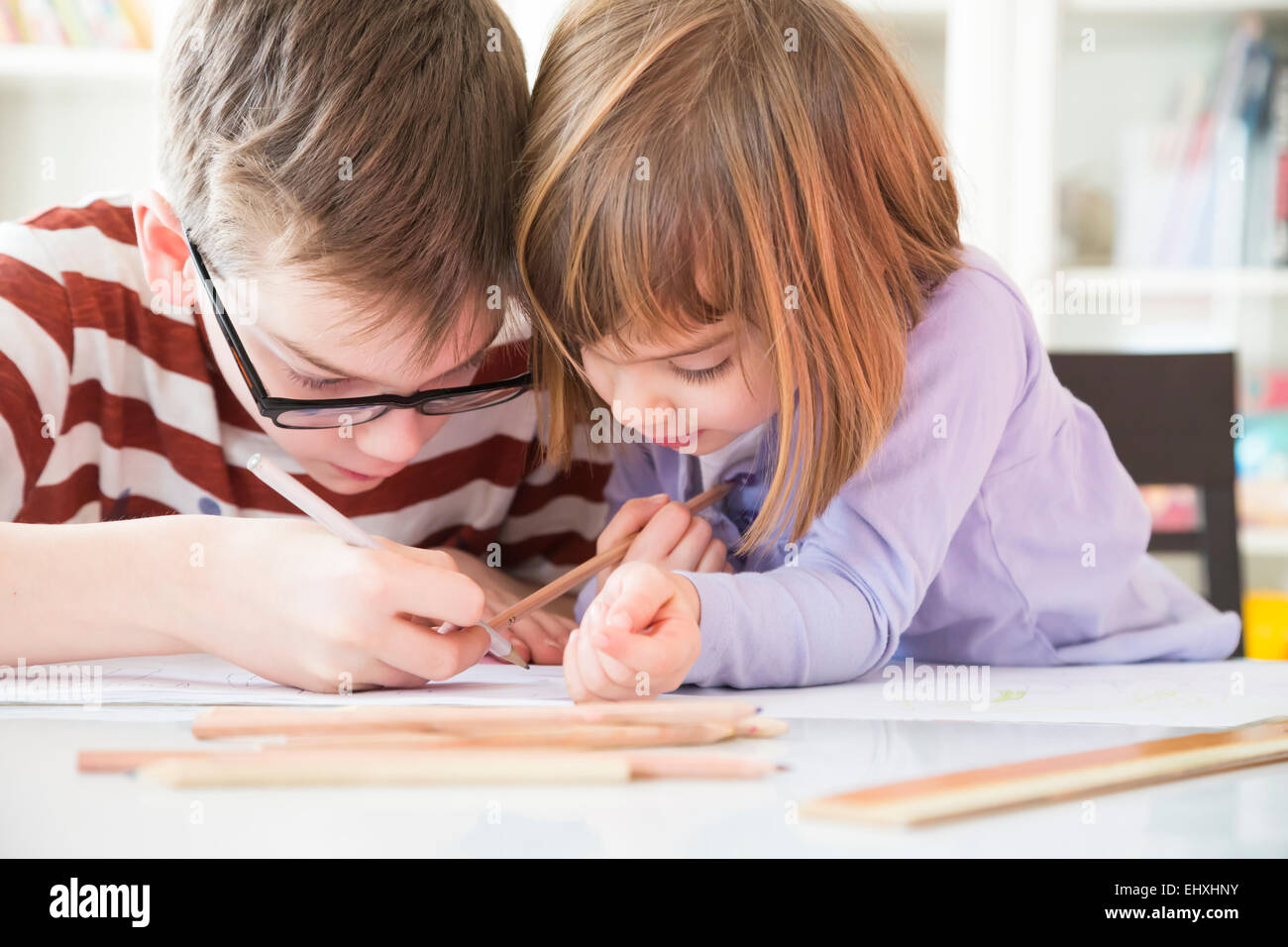 Brother and sister drawing together Stock Photo - Alamy