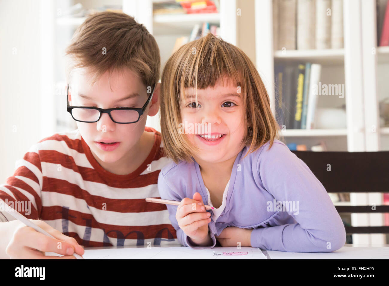 Side view caucasian siblings drawing hi-res stock photography and ...
