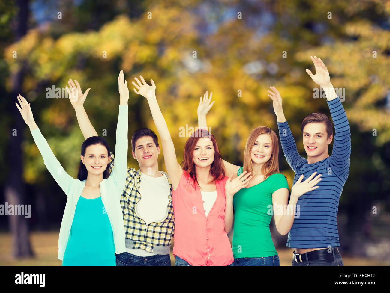 group of smiling students waving hands Stock Photo - Alamy