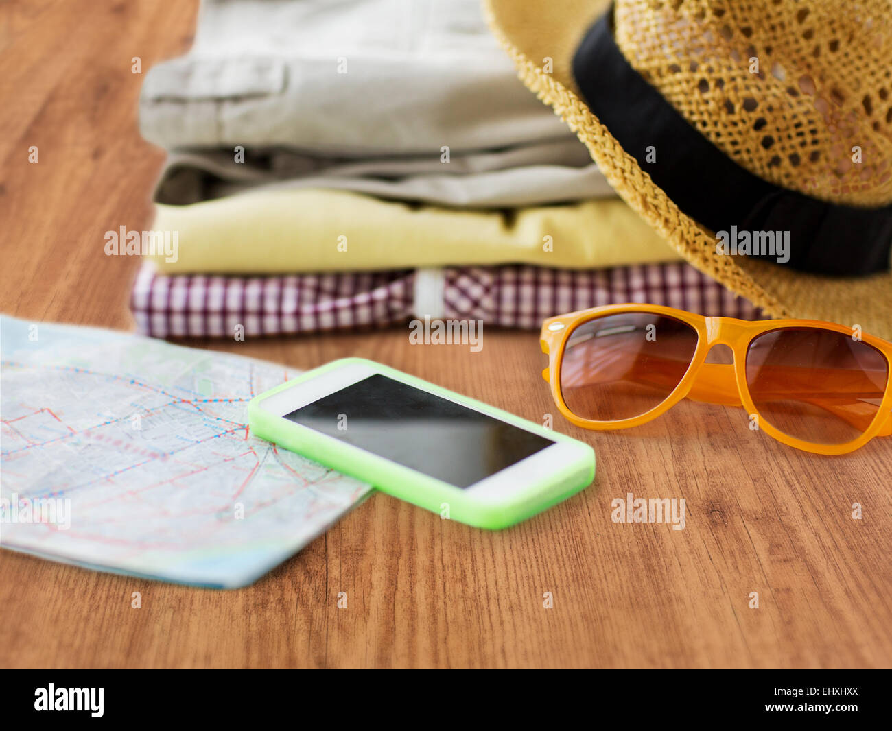close up of summer clothes and travel map on floor Stock Photo - Alamy