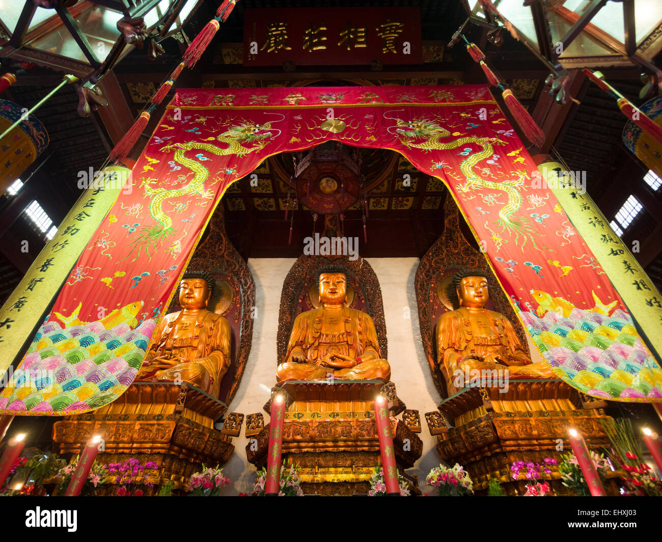 Three Buddah golden statues of at the Jade Buddha temple in Shanghai ...